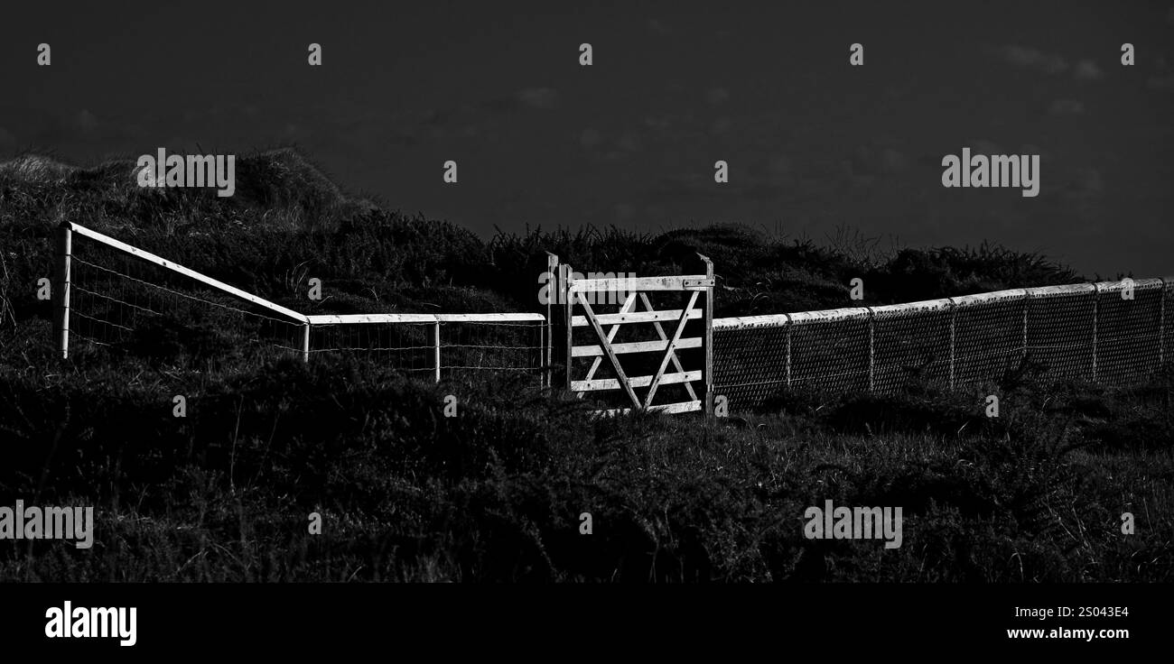 white fence and gate on clifftop edge Stock Photo - Alamy
