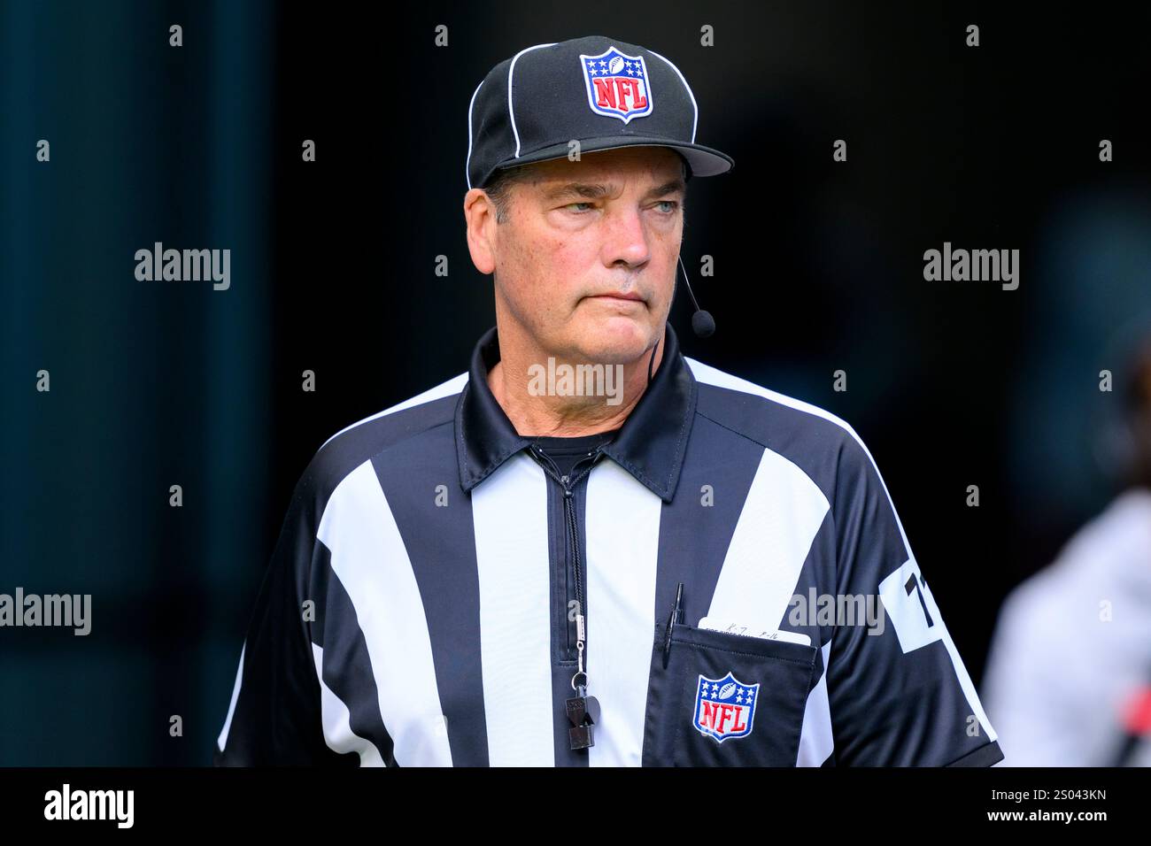 NFL side judge David Maslow walks onto the field before an NFL football ...