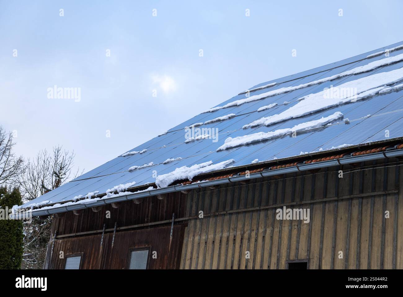 Bavaria, Germany - December 24, 2024: Partially snow-covered solar ...