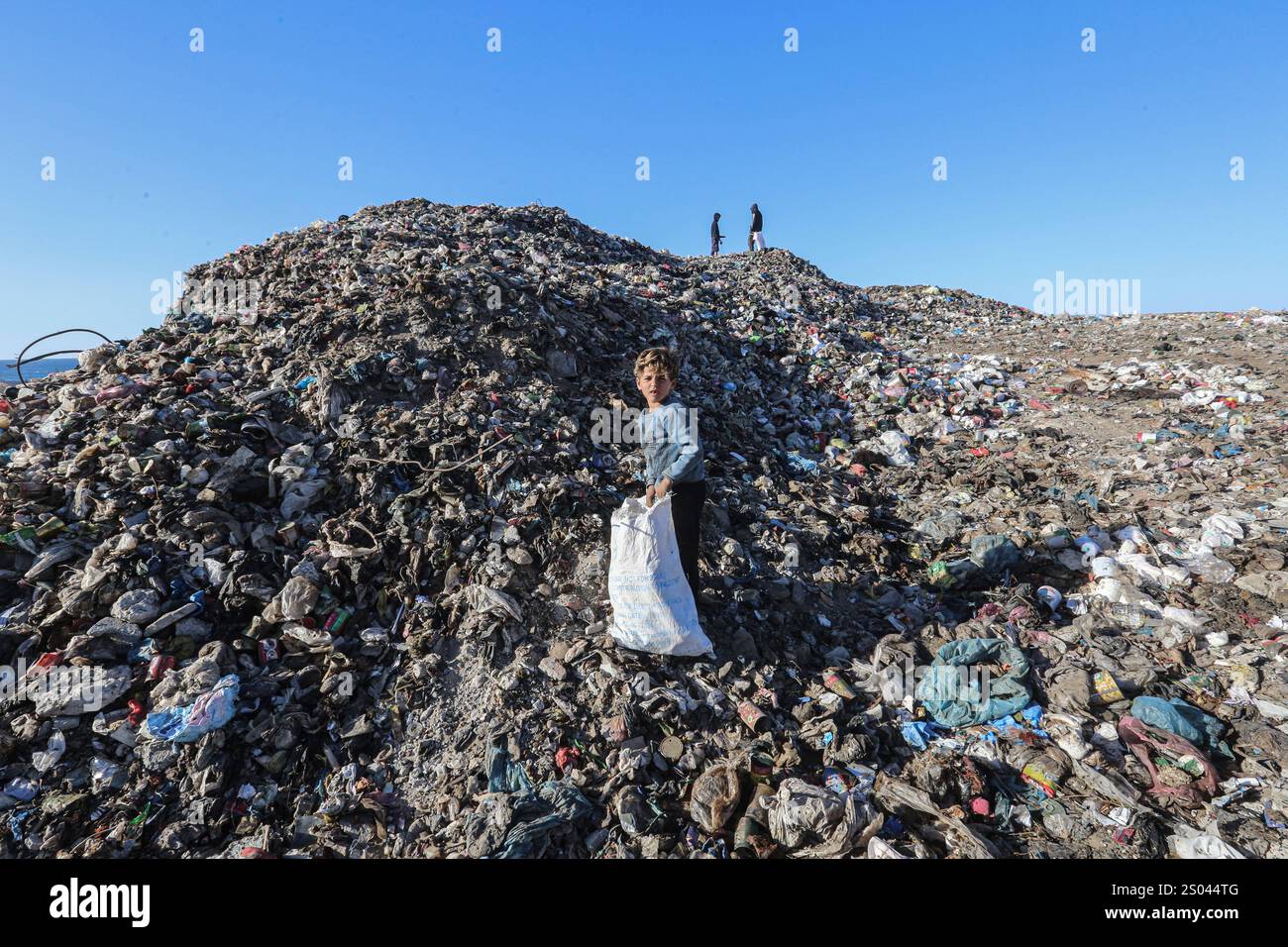A view of the area where people live in makeshift tents near trash ...