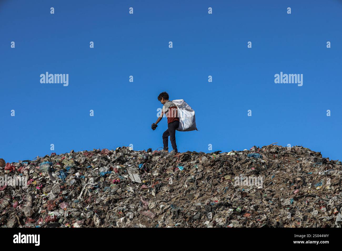 A view of the area where people live in makeshift tents near trash ...