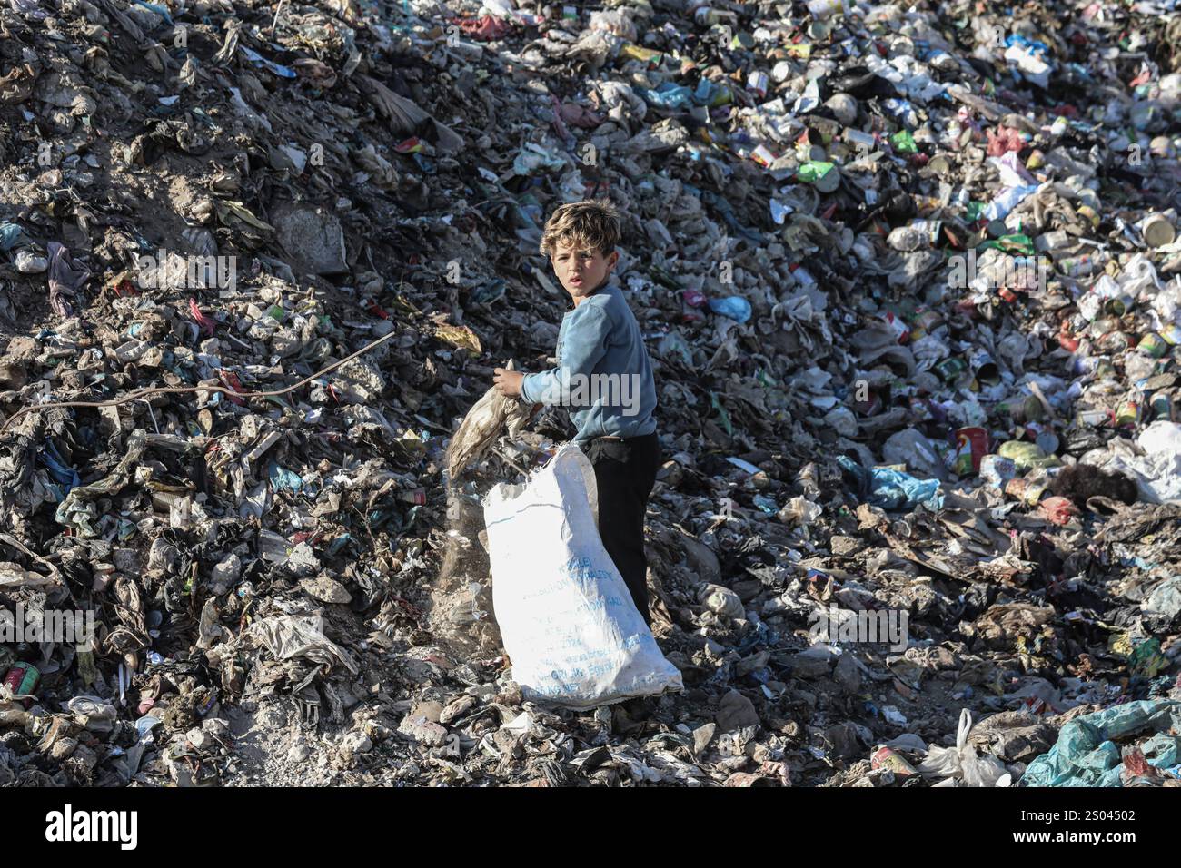 A view of the area where people live in makeshift tents near trash ...