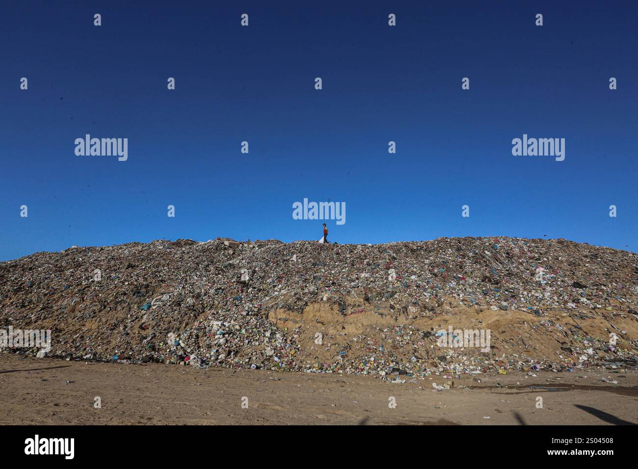 A view of the area where people live in makeshift tents near trash ...