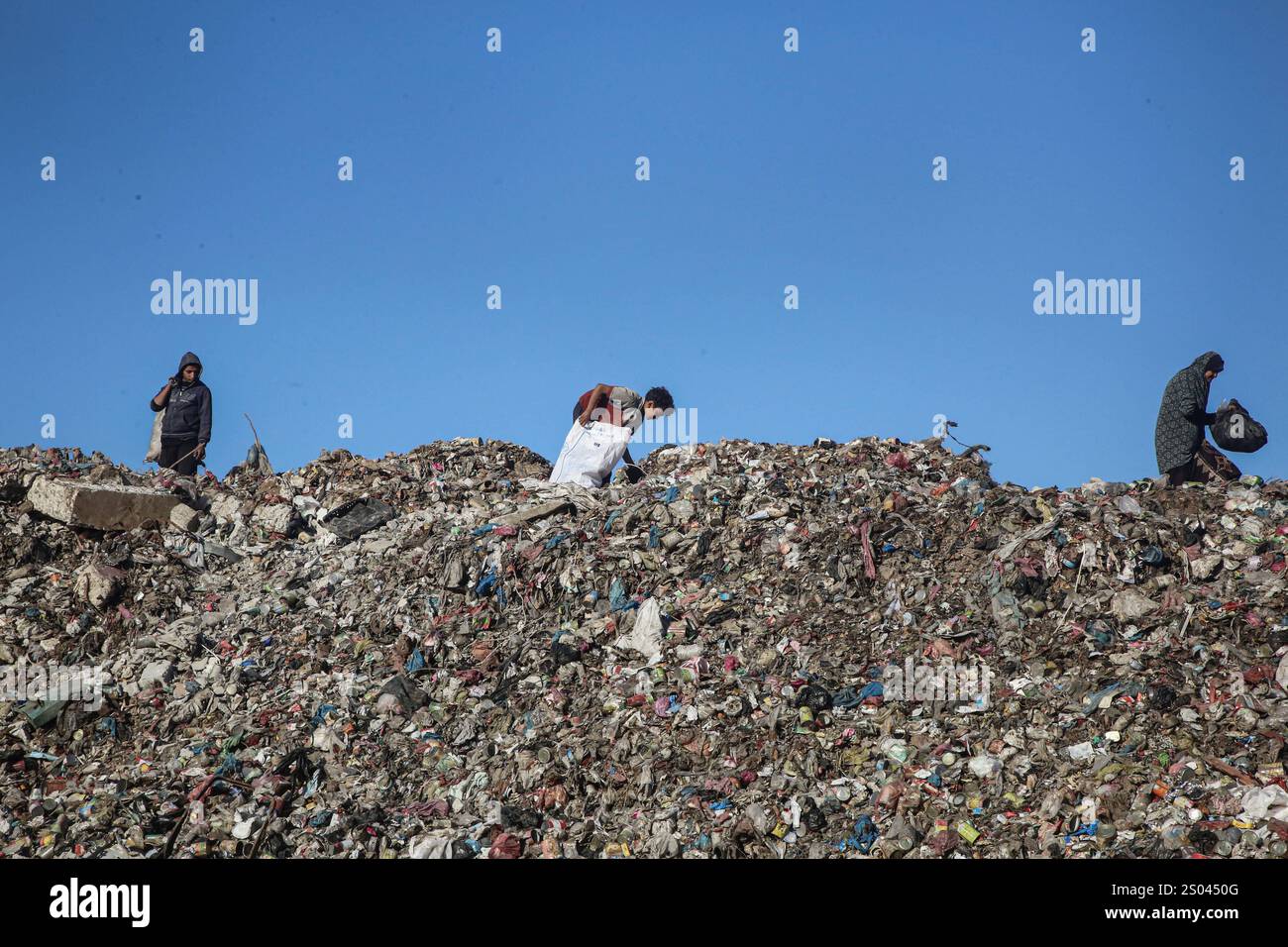 A view of the area where people live in makeshift tents near trash ...