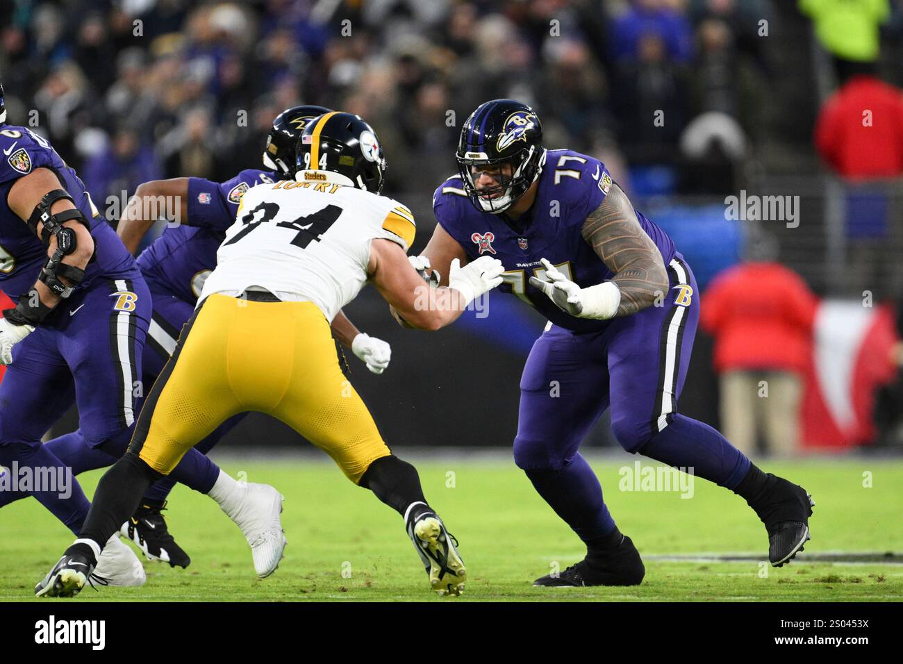 Baltimore Ravens offensive tackle Daniel Faalele (77) in action against ...