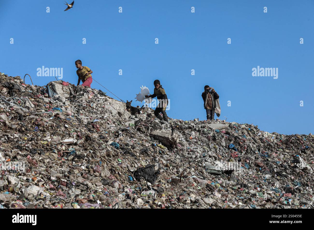 A view of the area where people live in makeshift tents near trash ...