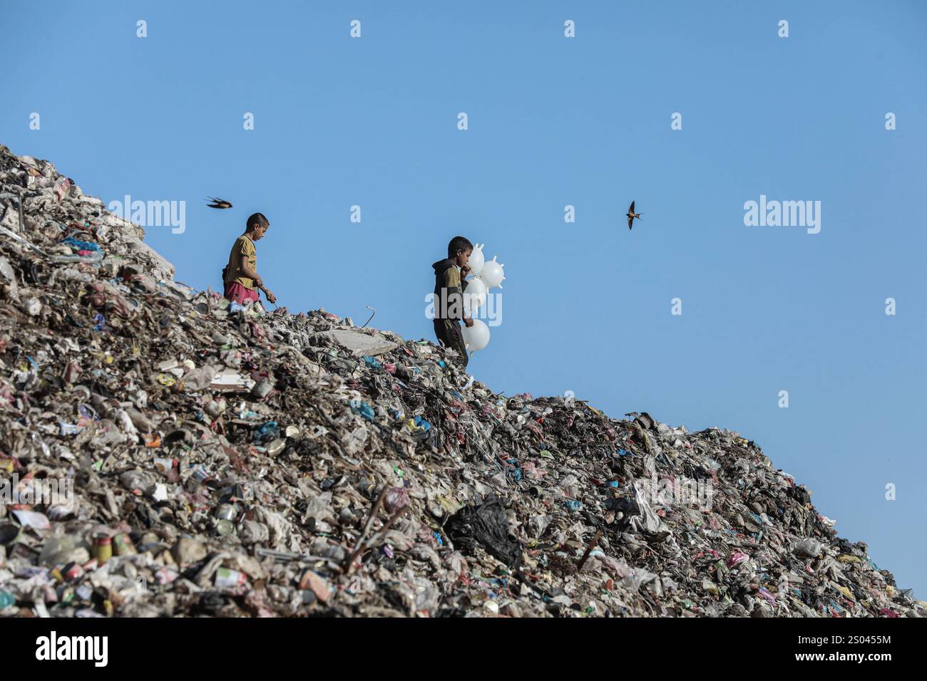A view of the area where people live in makeshift tents near trash ...