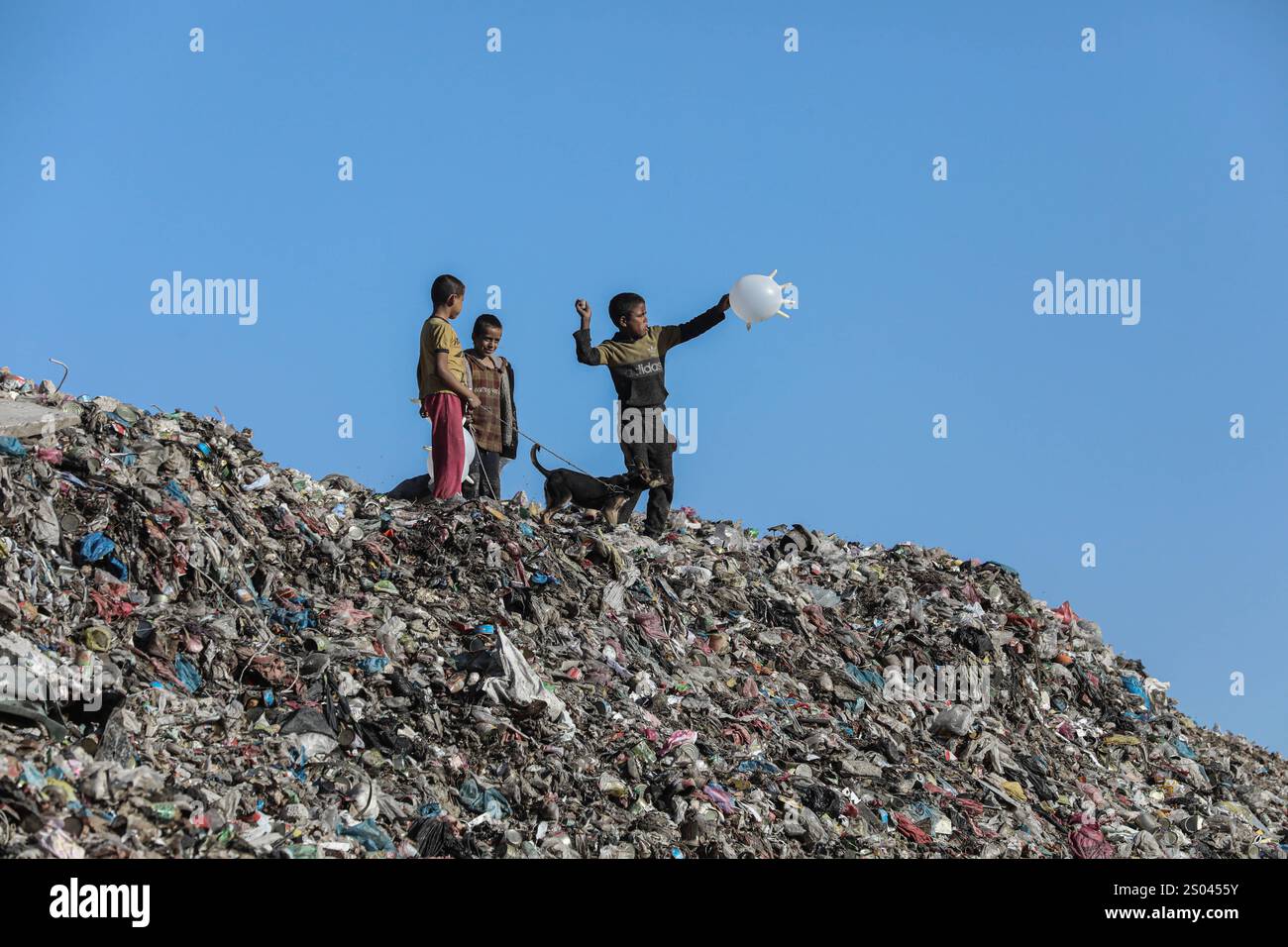 A view of the area where people live in makeshift tents near trash ...