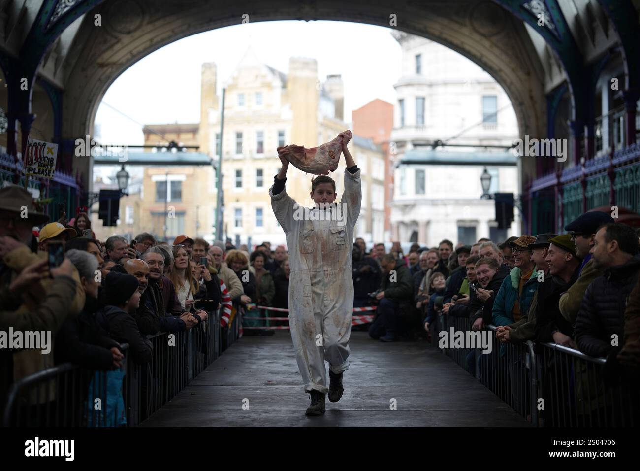 George Gardner displays a cut of meat for sale to customers during the ...