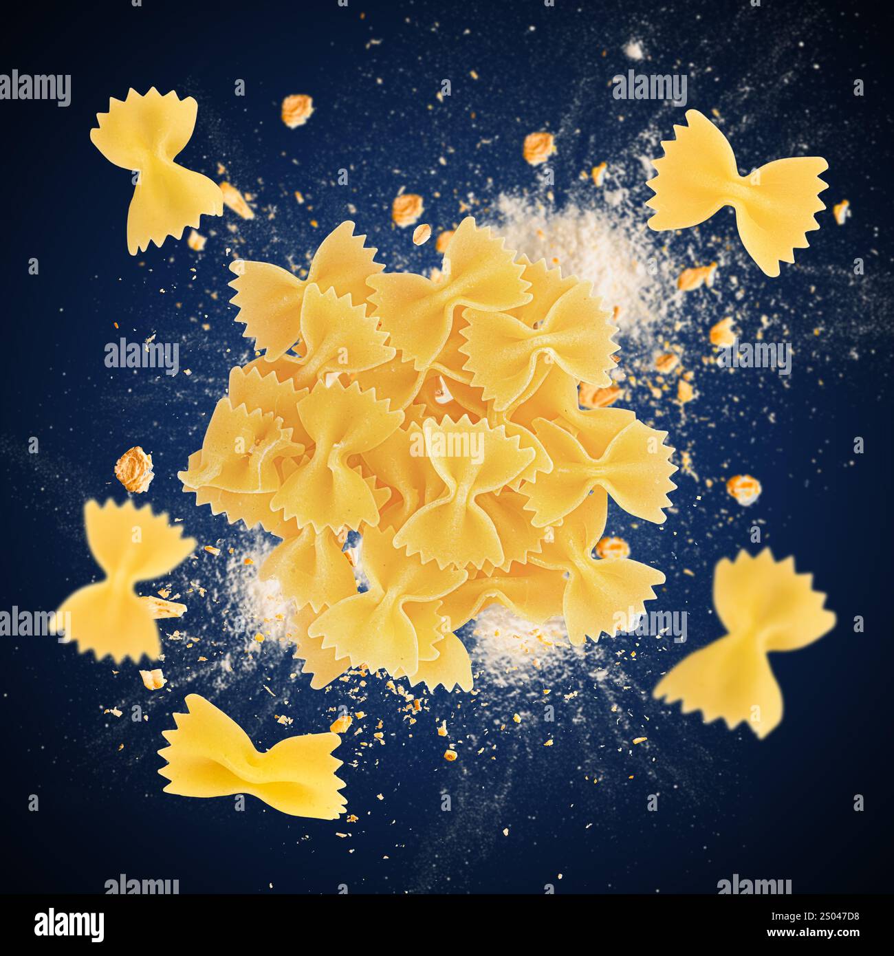 Uncooked farfalle pasta exploding on a blue background, creating a ...