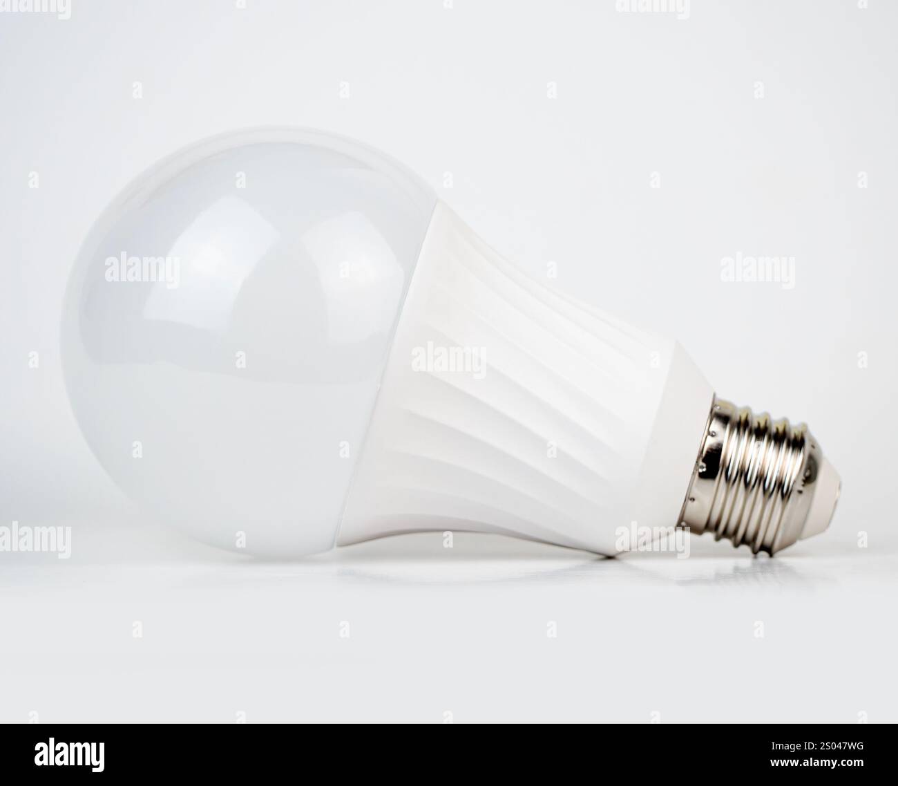A bright, modern light bulb isolated on white background Stock Photo ...