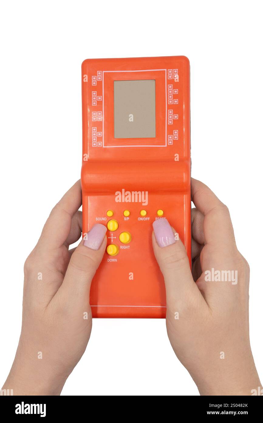 Close-up of a red handheld game console in female hands isolated on ...