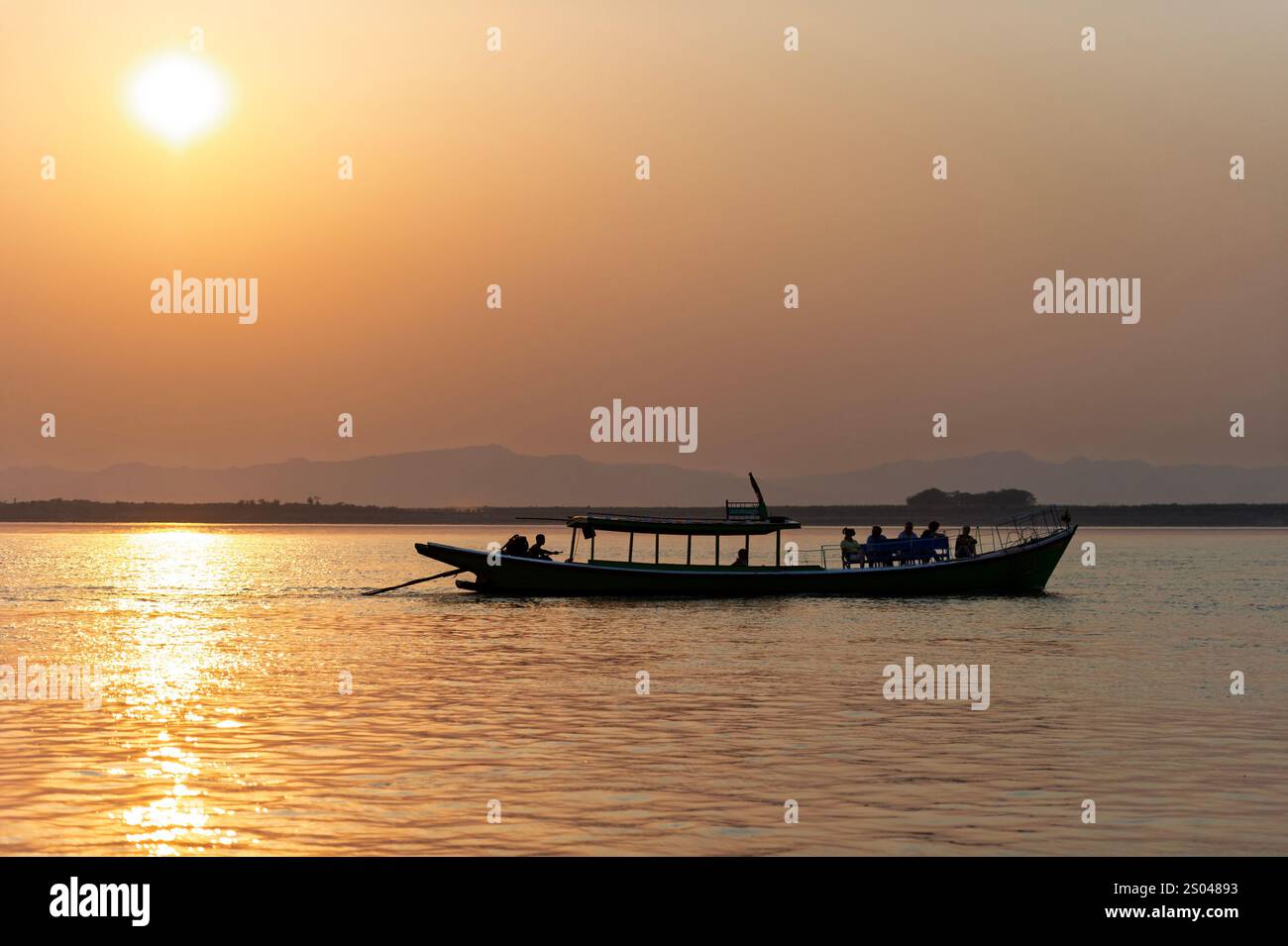 A tour riverboat on the Irrawaddy River at sunset. Myanmar Burma Stock Photo - Alamy