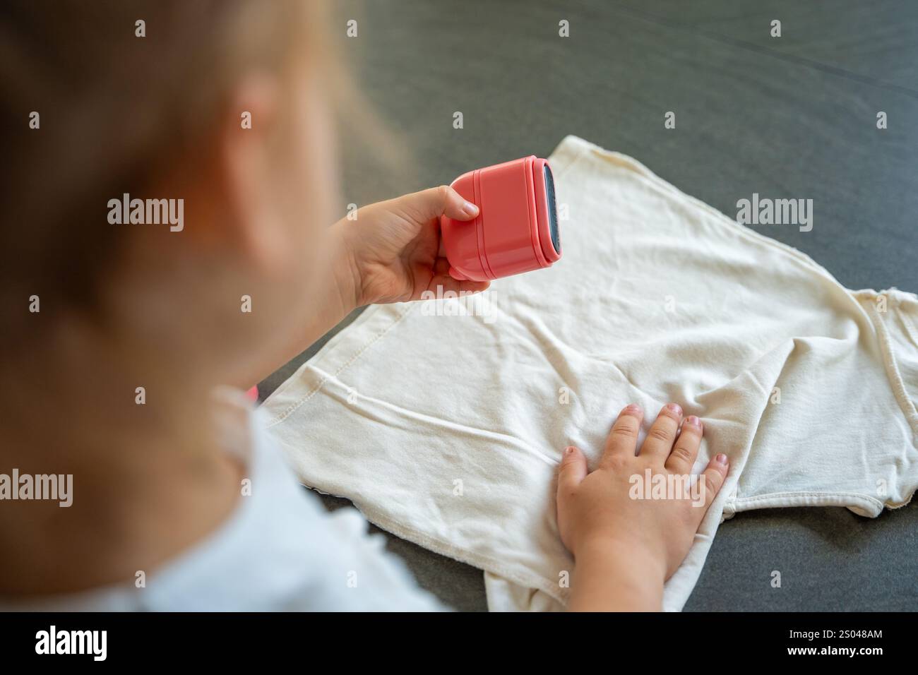 Back view of little girl with a stamp with a name for signing children ...