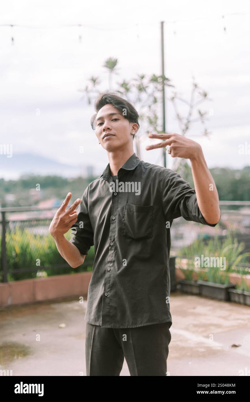 Southeast Asian man making a hand gesture with bold expression. Focus ...