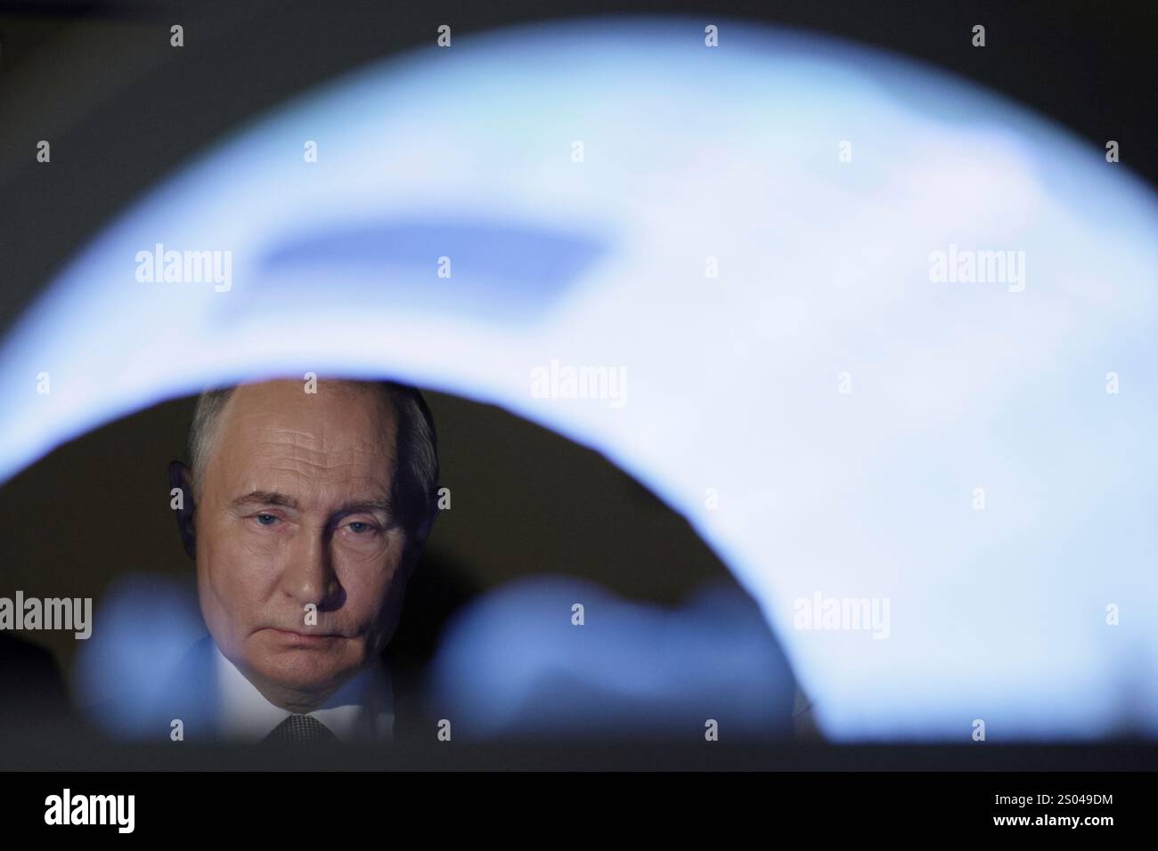 Russian President Vladimir Putin examines the model of the new building ...