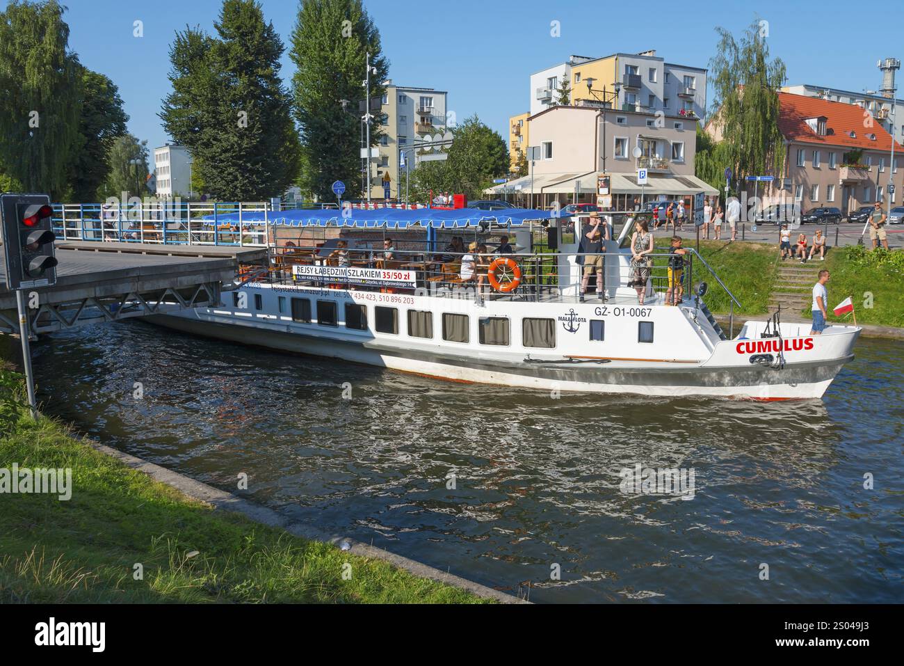White ship on a canal under a bridge in sunny weather, boat Cumulus on ...