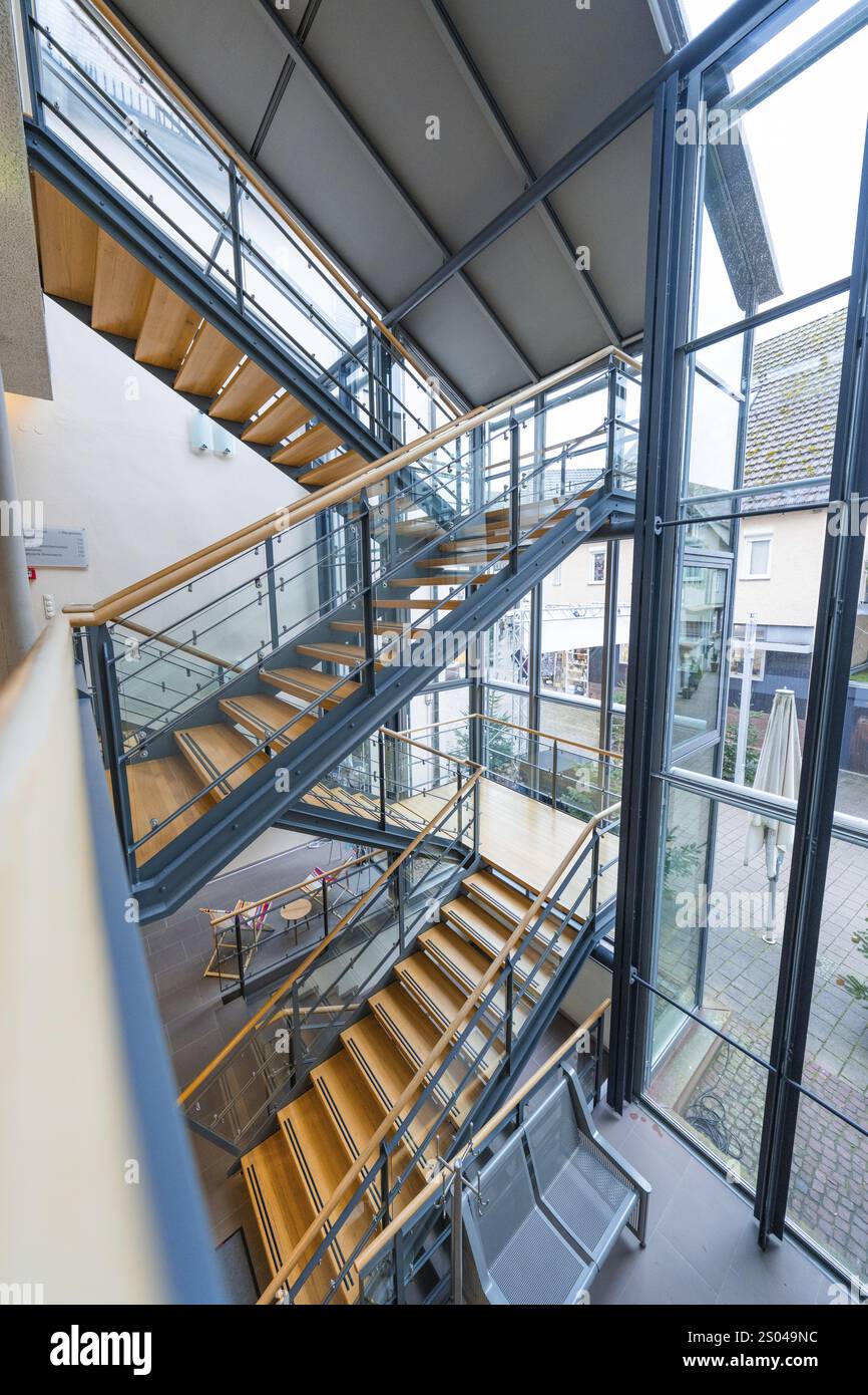 Modern, steel staircase in an urban building with large glass walls ...