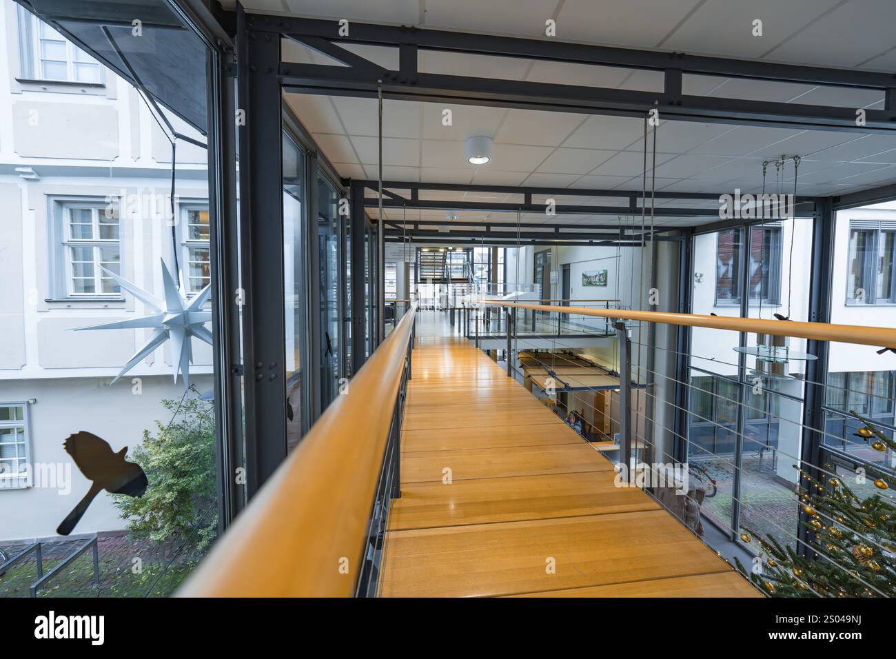 Light-flooded glass corridor with wooden floor in a modern building ...