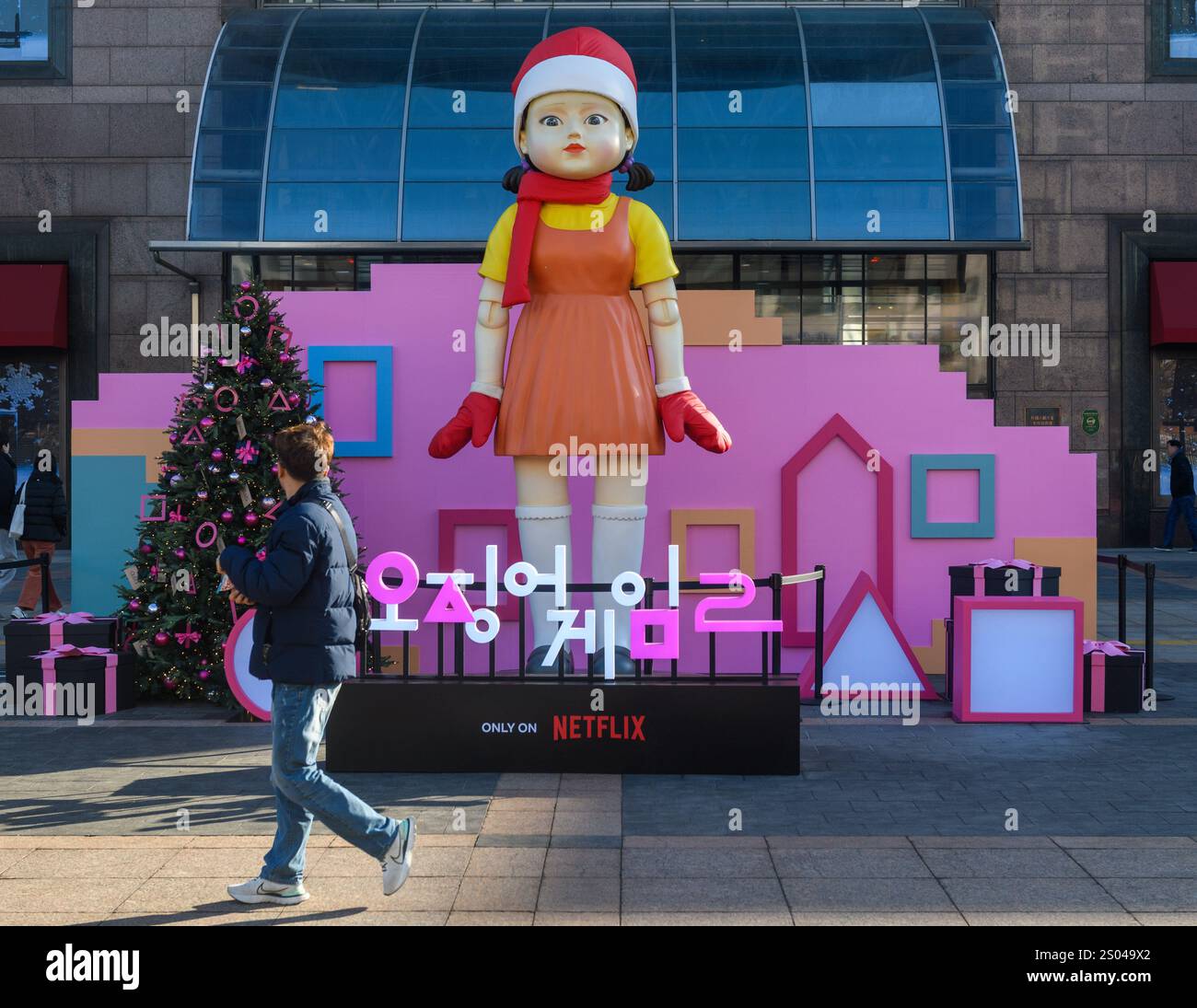 A man seen walking past a Young-hee, the iconic doll in the Netflix ...