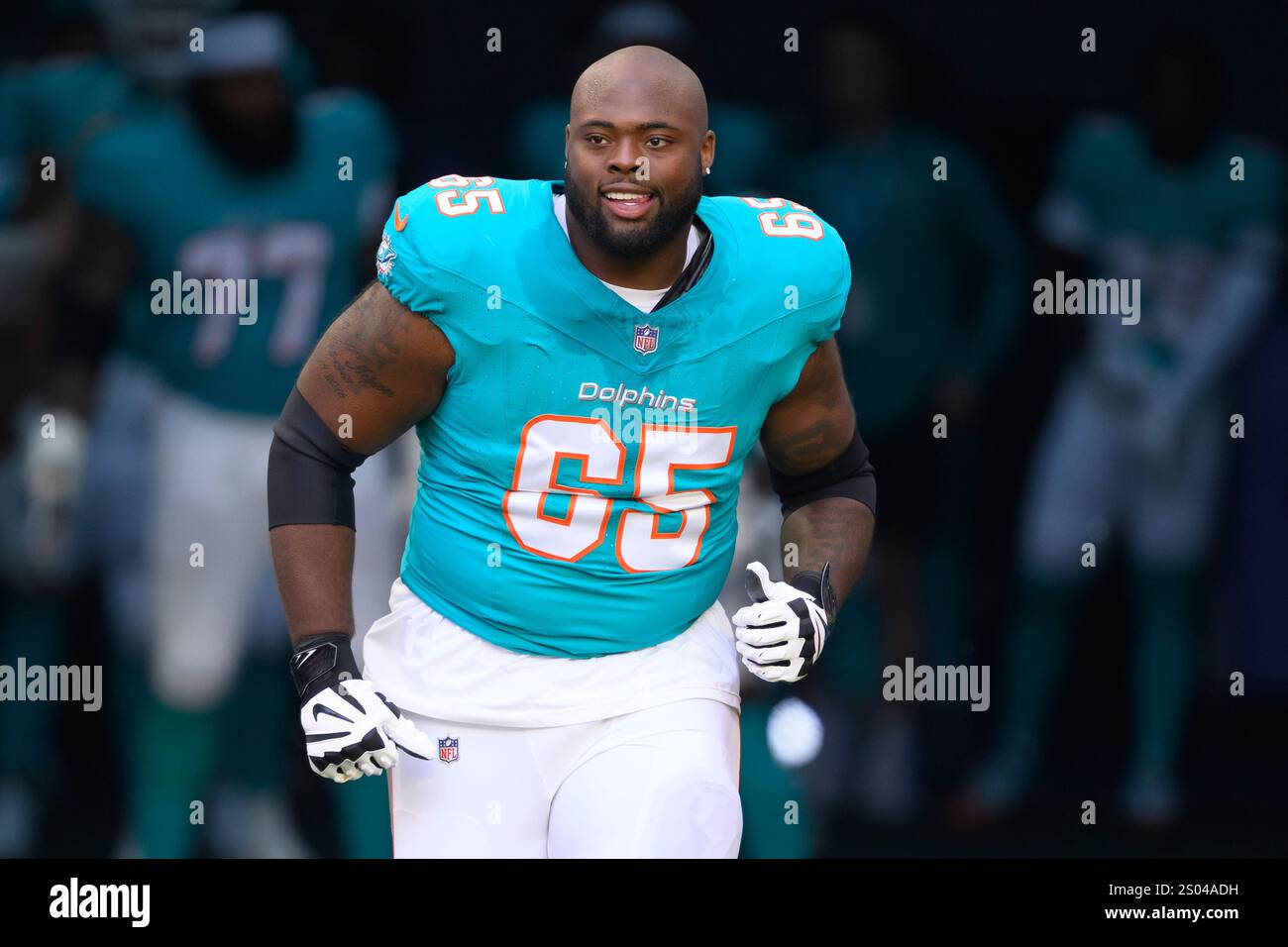 Miami Dolphins offensive lineman Robert Jones (65) smiles as he runs ...