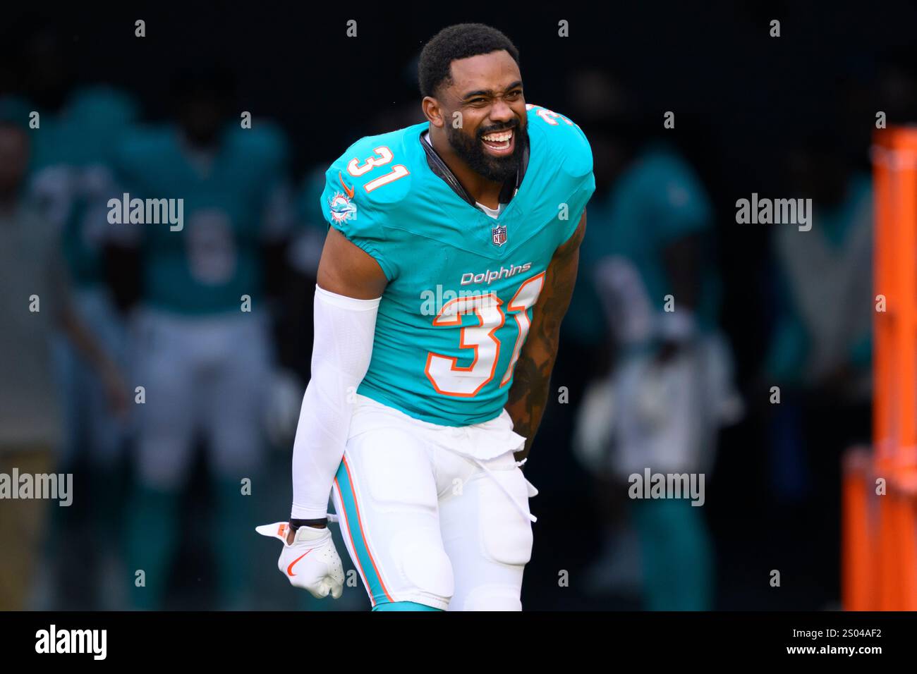 Miami Dolphins running back Raheem Mostert (31) yells as he runs onto the field during player ...
