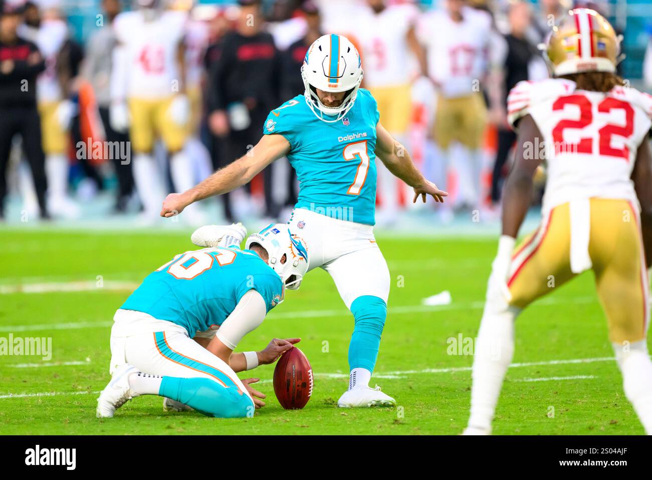 Miami Dolphins punter Jake Bailey (16) holds the ball as kicker Jason Sanders (7) kicks a field ...