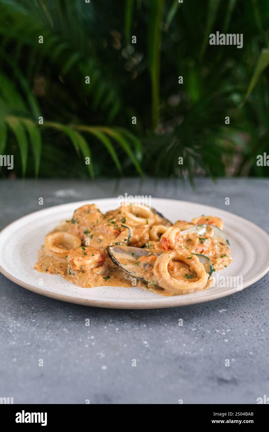 Creamy seafood dish with mussels, calamari rings, and shrimp in a rich ...