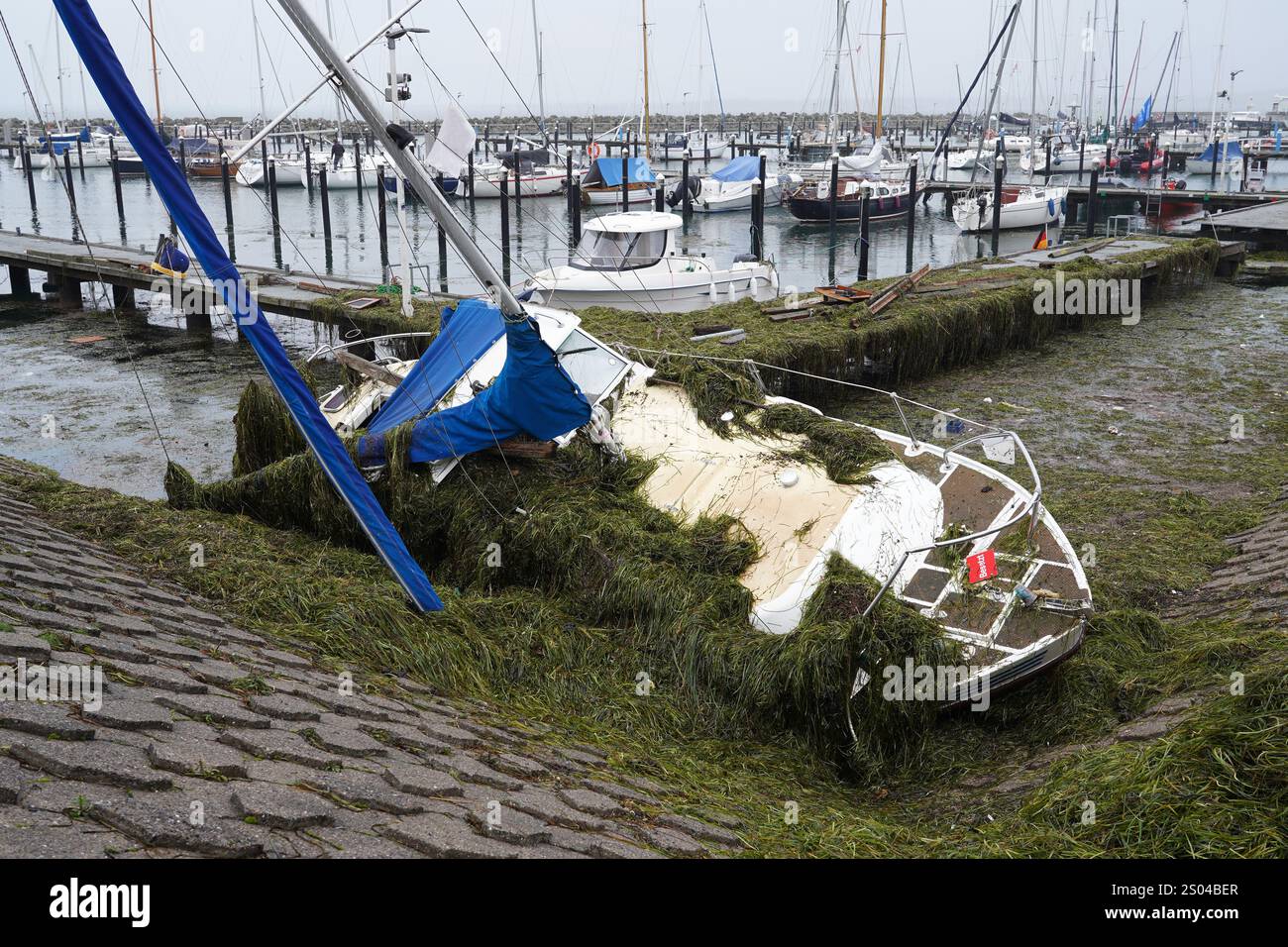 Damaged boat after storm surge in northern Europe Stock Photo - Alamy