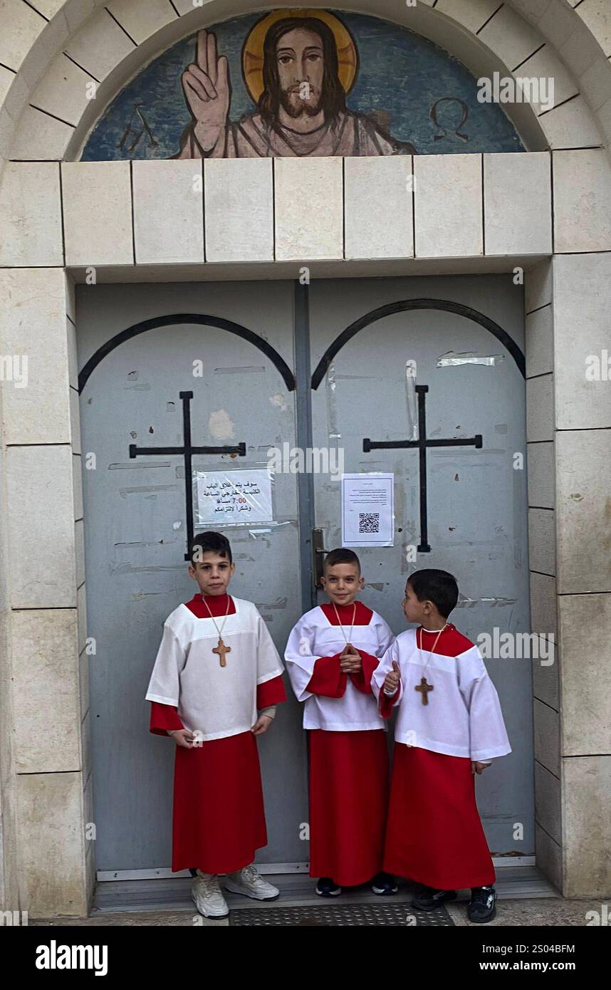 Palestinian Christians participate in the Christmas Mass at the Church ...