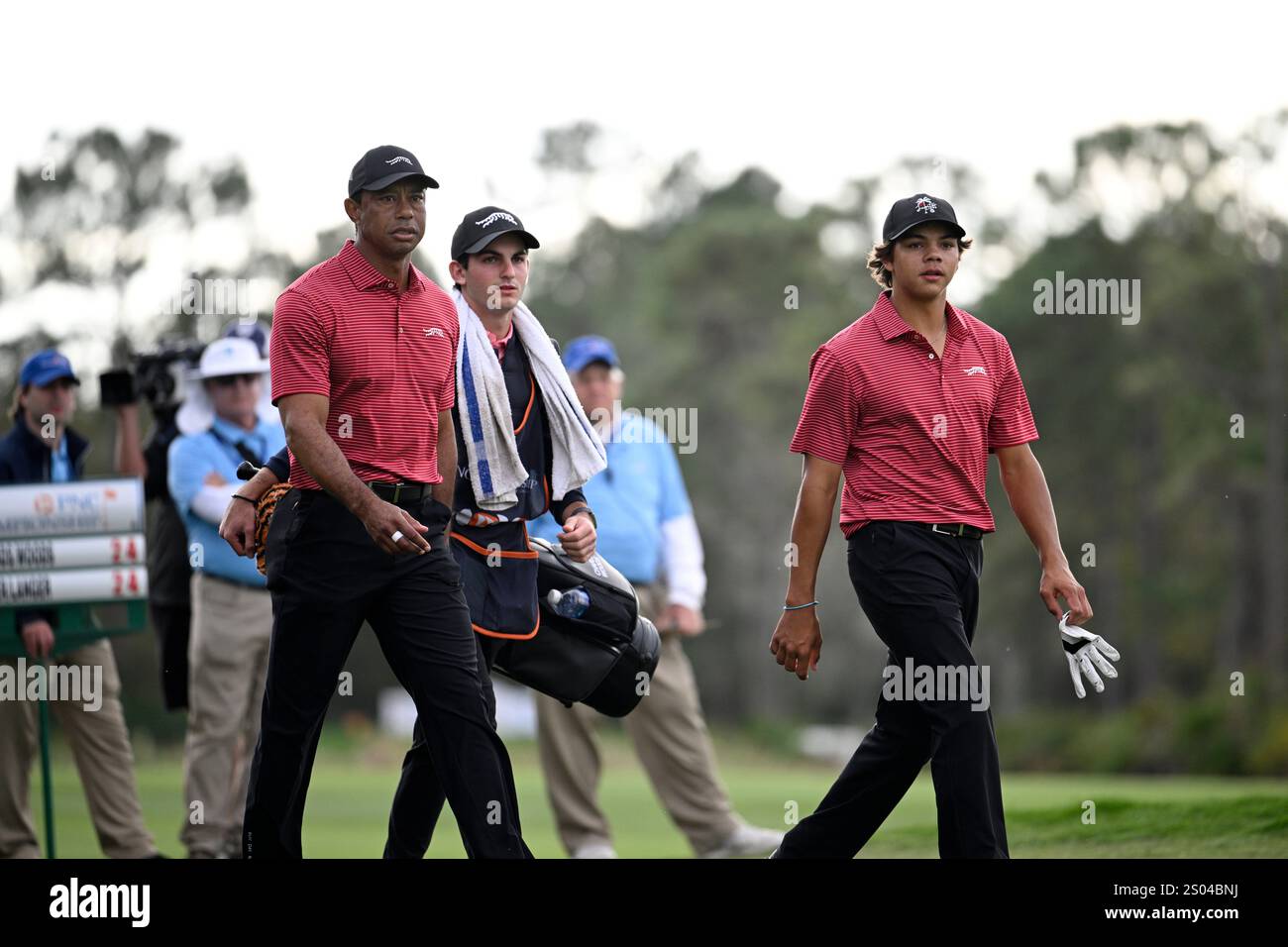 Tiger Woods, left, and his son Charlie Woods, right, walk with Luke ...
