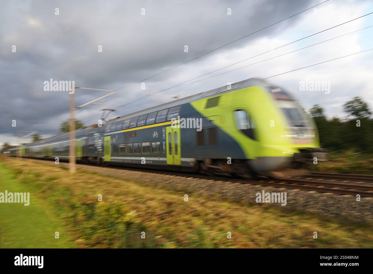 A modern green colored german electric passenger train passing by Stock ...