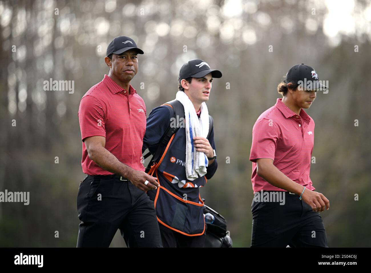 Tiger Woods, left, and his son Charlie Woods, right, walk with Luke ...