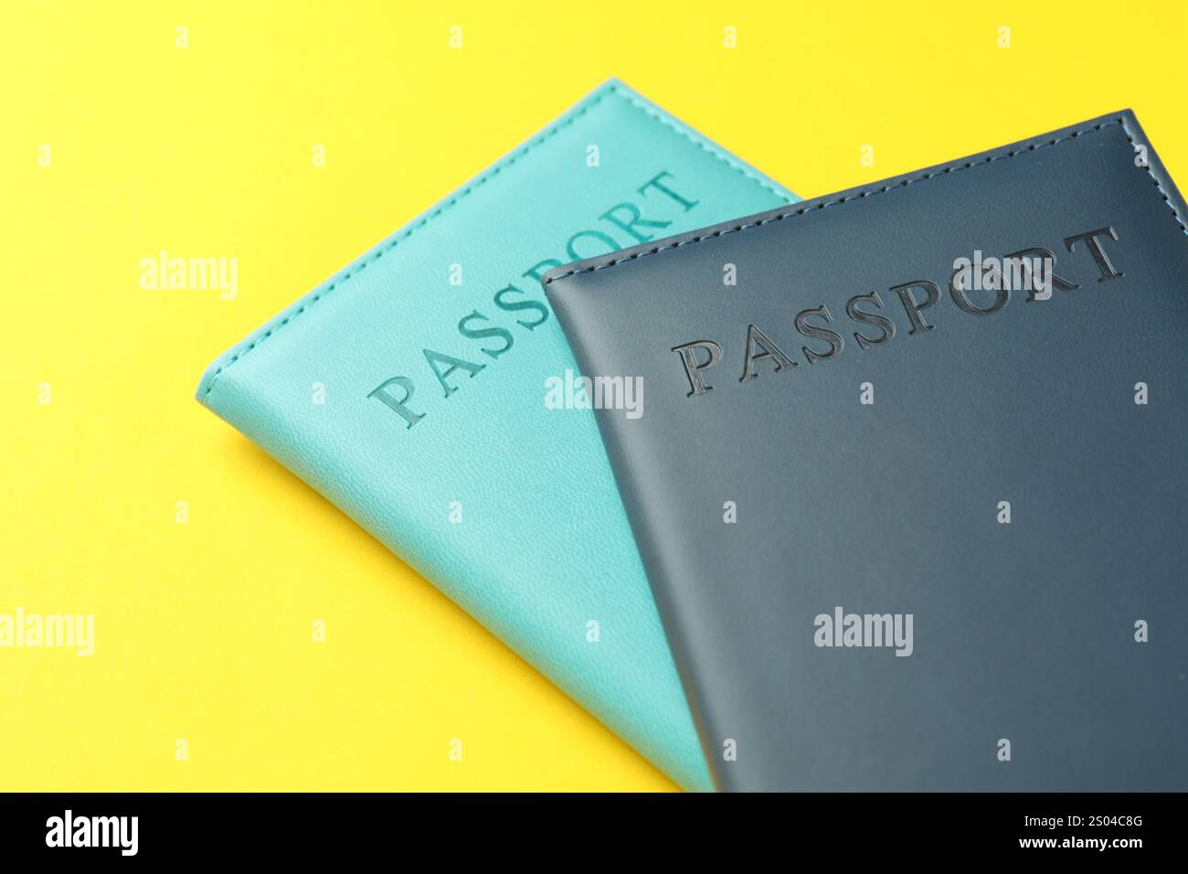 Passports in color covers on yellow background, closeup Stock Photo - Alamy