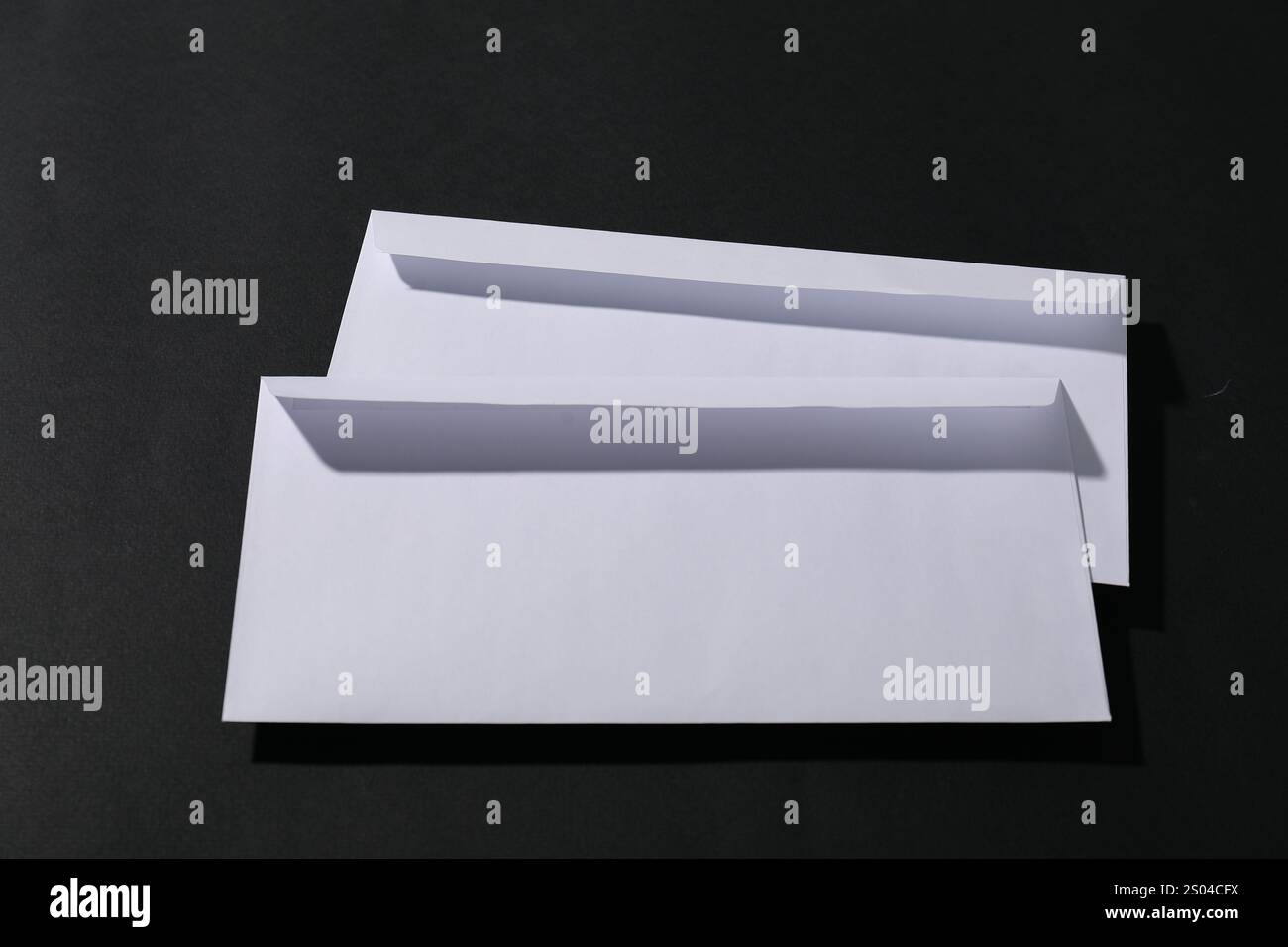 Paper envelopes on black background, above view. Mockup for design ...