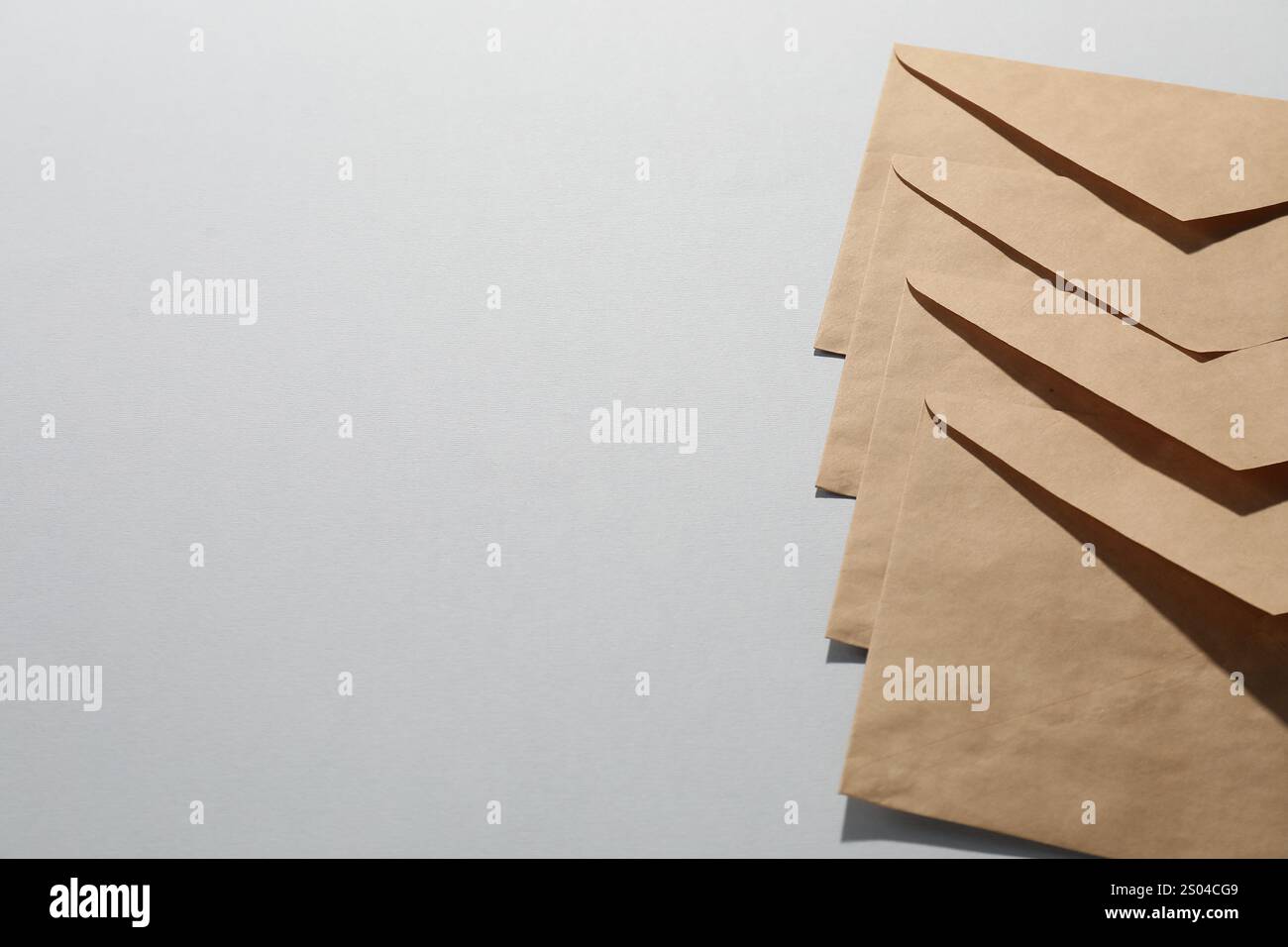 Kraft paper envelopes on grey background, above view. Mockup for design ...