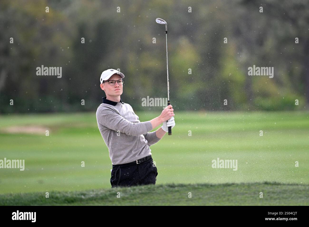 Jason Langer watches after hitting from a bunker onto the 14th green ...