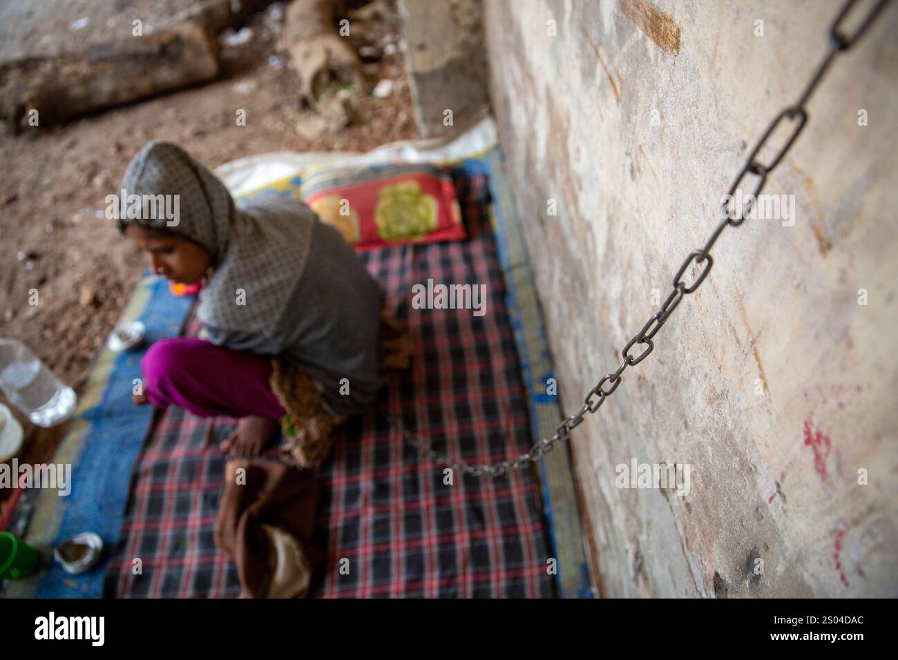 A mentally disabled girl is confined with chains beside a roadside in ...