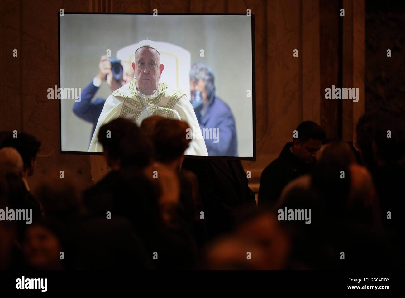 A giant monitor shows Pope Francis pausing before entering the holy ...