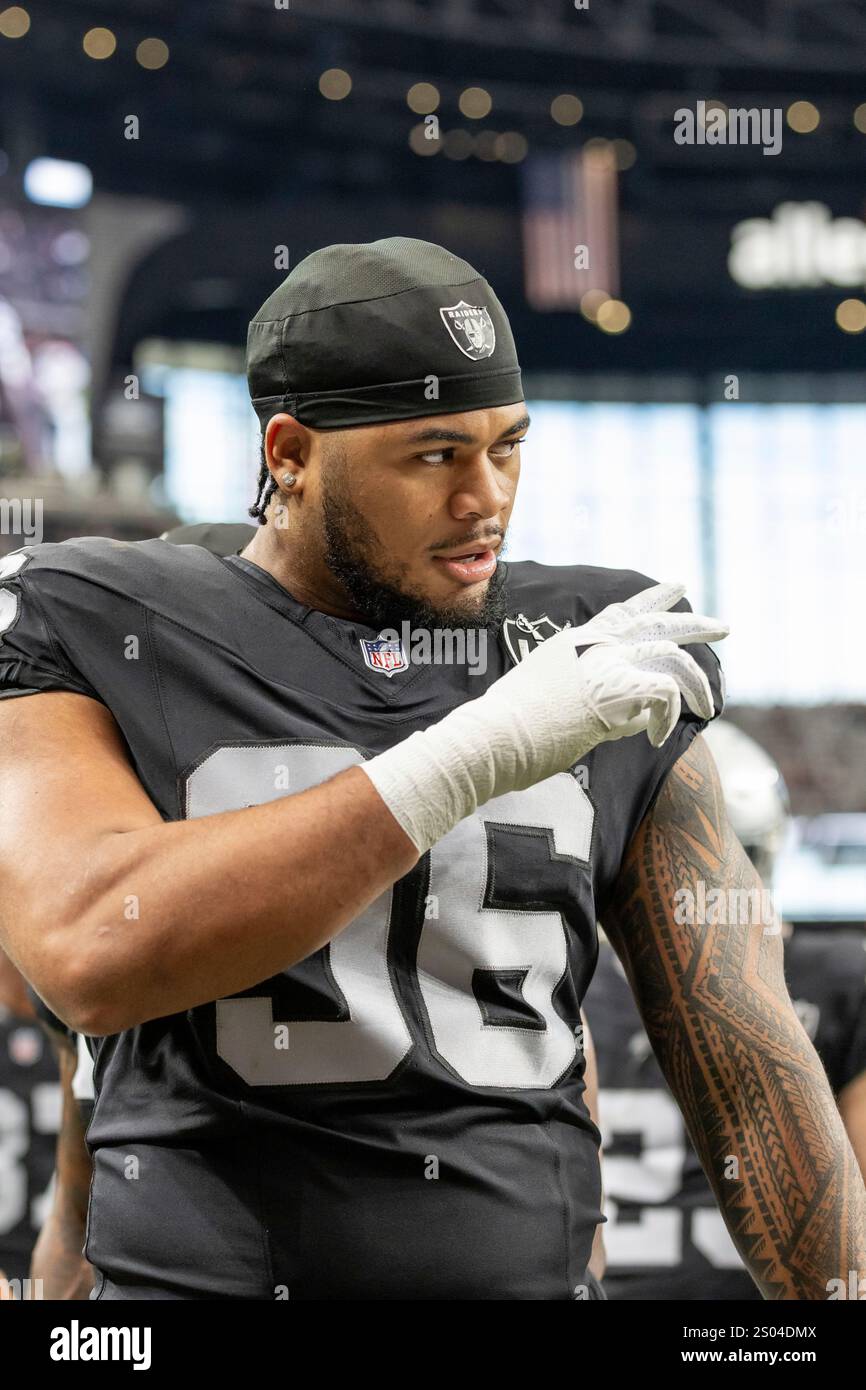 Las Vegas Raiders defensive tackle Jonah Laulu (96) walks off the field ...