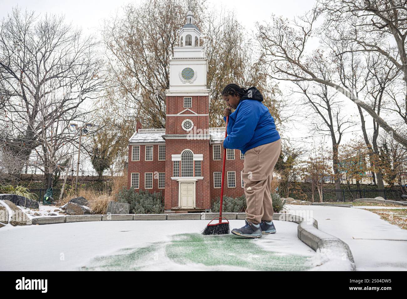 Staff member Taniesha Getter brushes off the snow on the Philly Mini ...