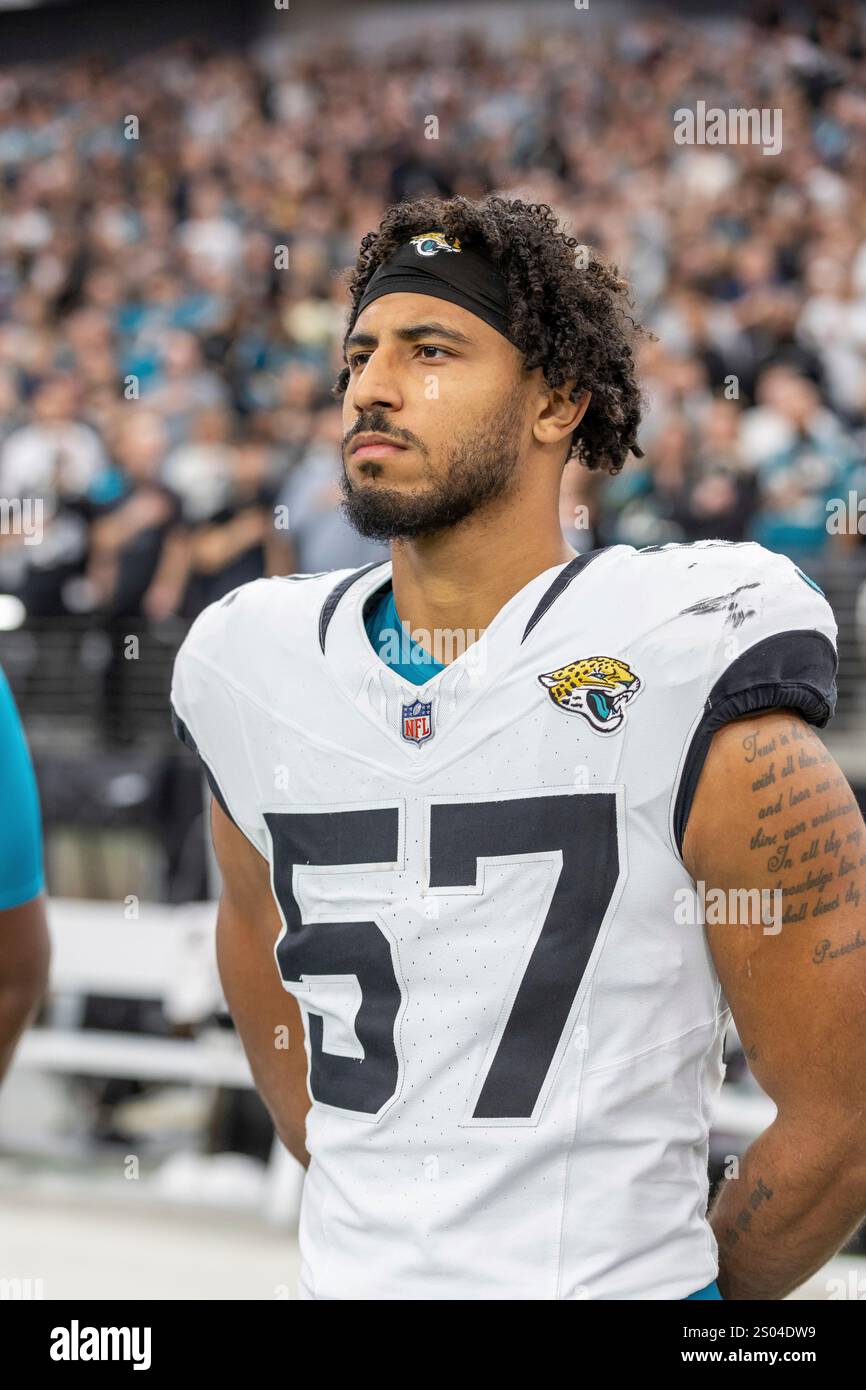 Jacksonville Jaguars linebacker Caleb Johnson (57) stands for the national anthem before playing ...