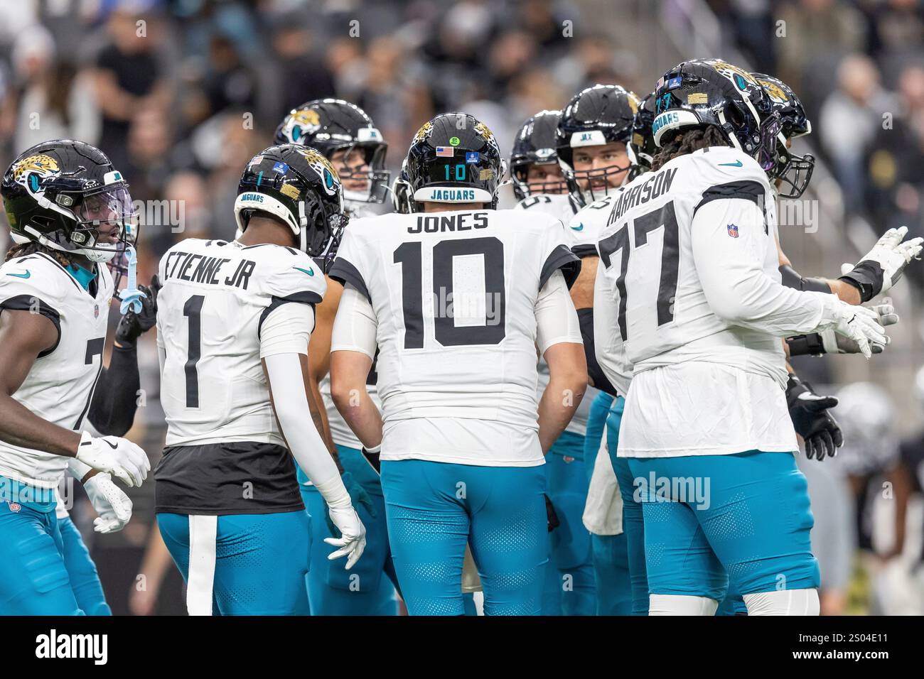 Jacksonville Jaguars quarterback Mac Jones (10) huddles with the offense against the Las Vegas ...