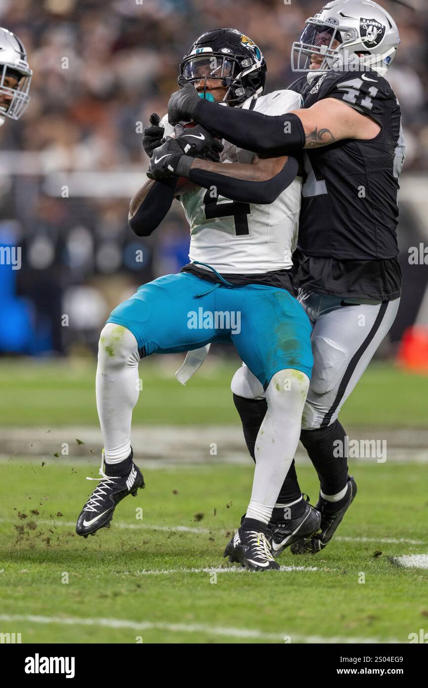 Las Vegas Raiders linebacker Robert Spillane (42) tackles Jacksonville ...