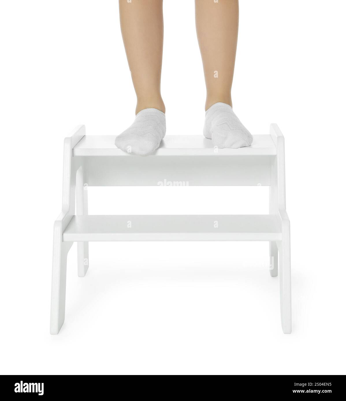 Little girl standing on step stool against white background, closeup ...