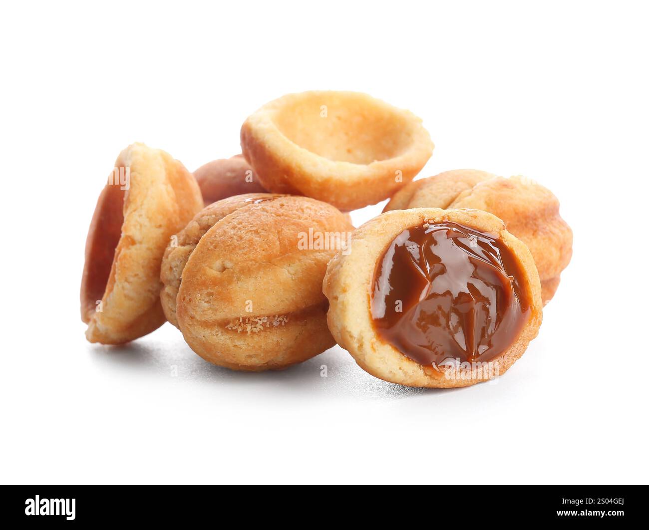 Many sweet walnut shaped cookies with boiled condensed milk on white ...