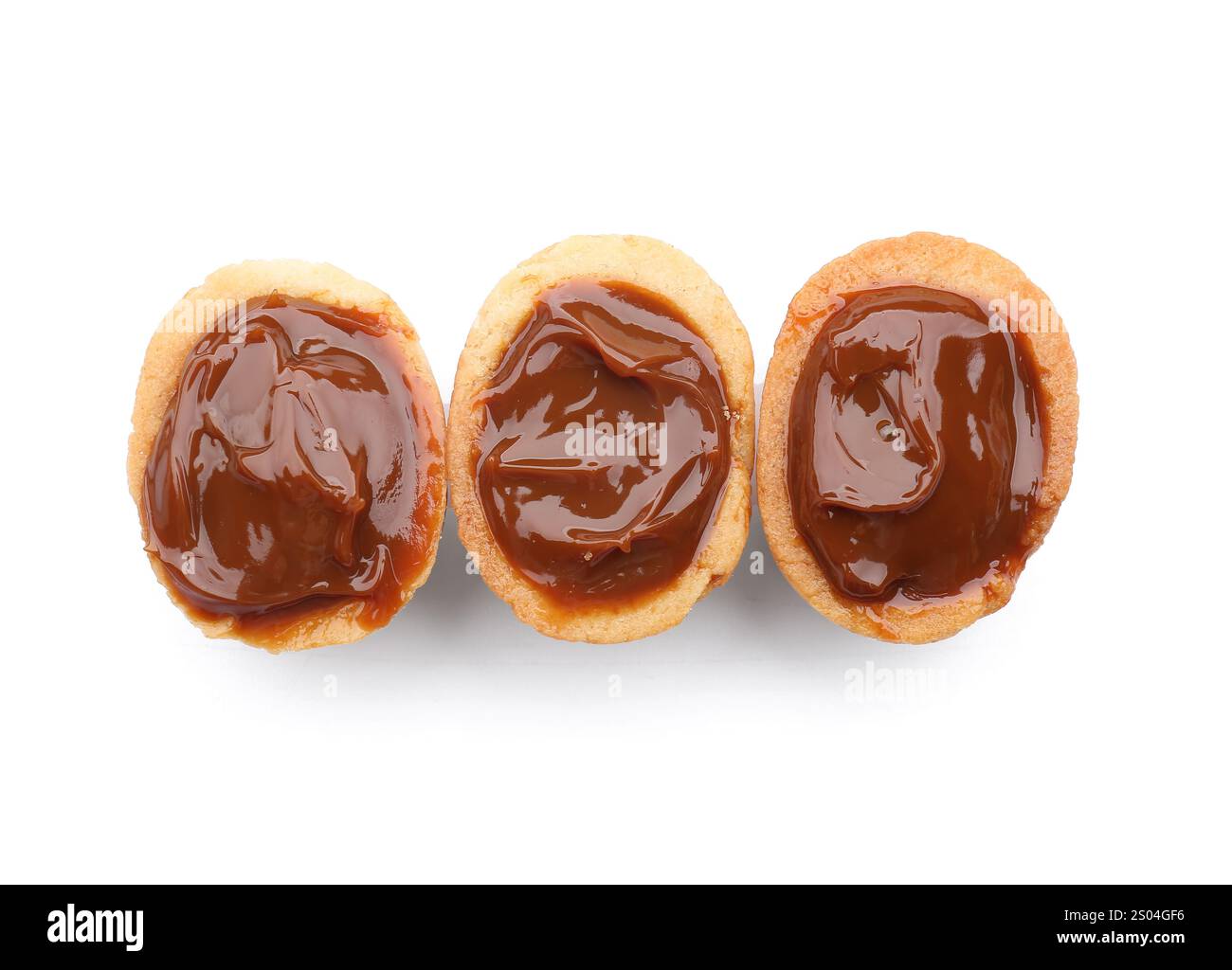 Halves of sweet walnut shaped cookies with boiled condensed milk on ...