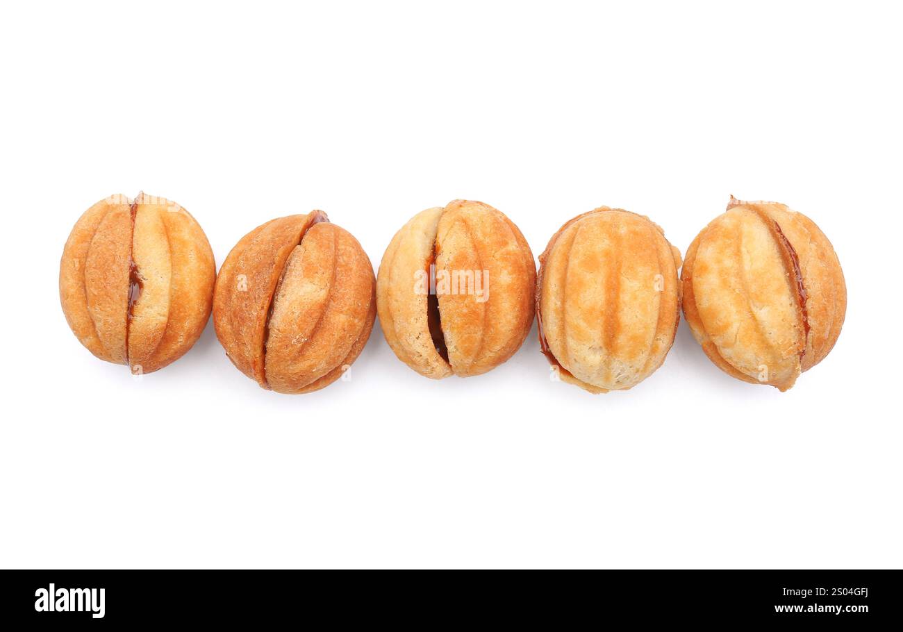Many sweet walnut shaped cookies with boiled condensed milk on white ...