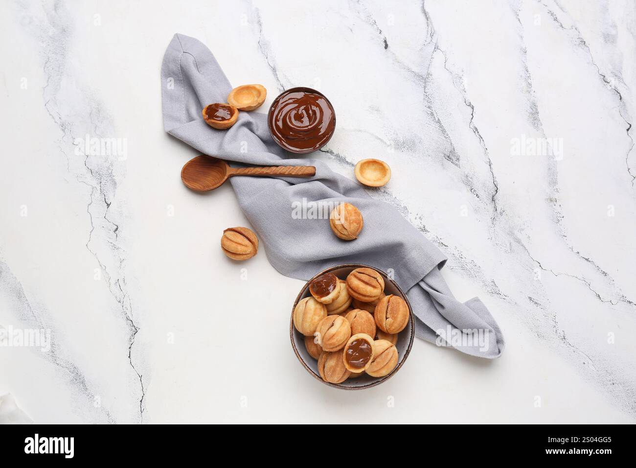 Bowl of sweet walnut shaped cookies with boiled condensed milk on white ...