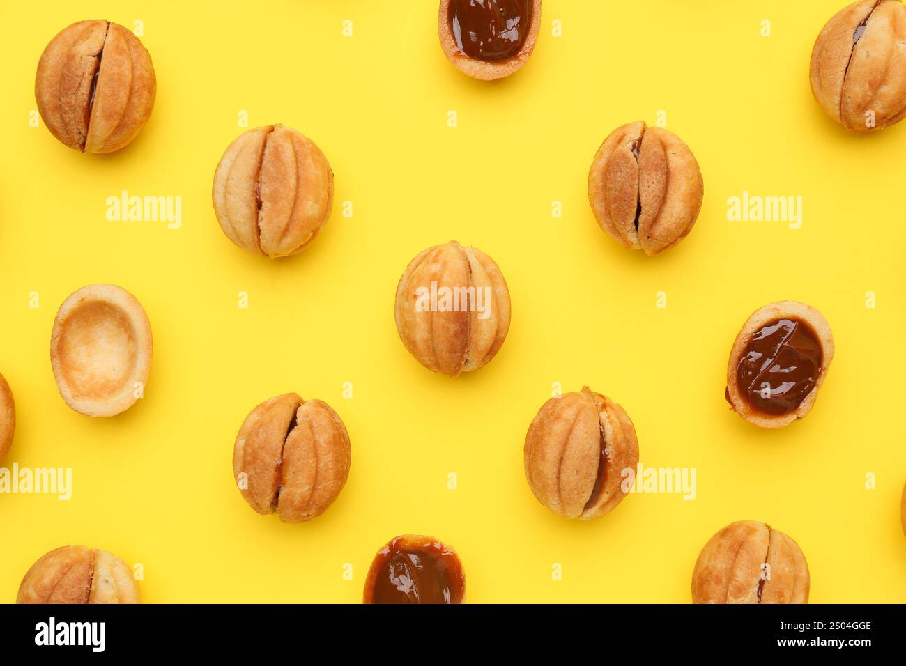 Sweet walnut shaped cookies with boiled condensed milk on yellow ...